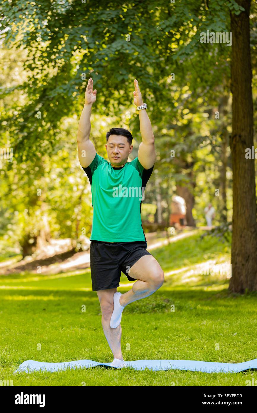 Calm muscular chinese sportsman balances hi-res stock photography and ...