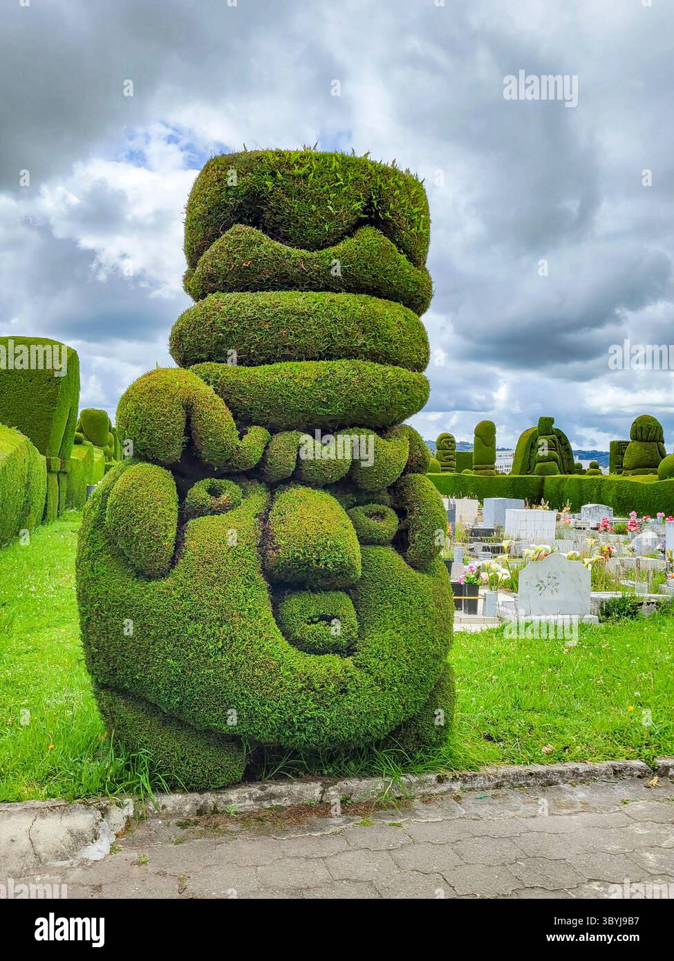 This topiary sculpture showcasing artistic bush trimming is located in Tulcán Cemetery, Ecuador ...