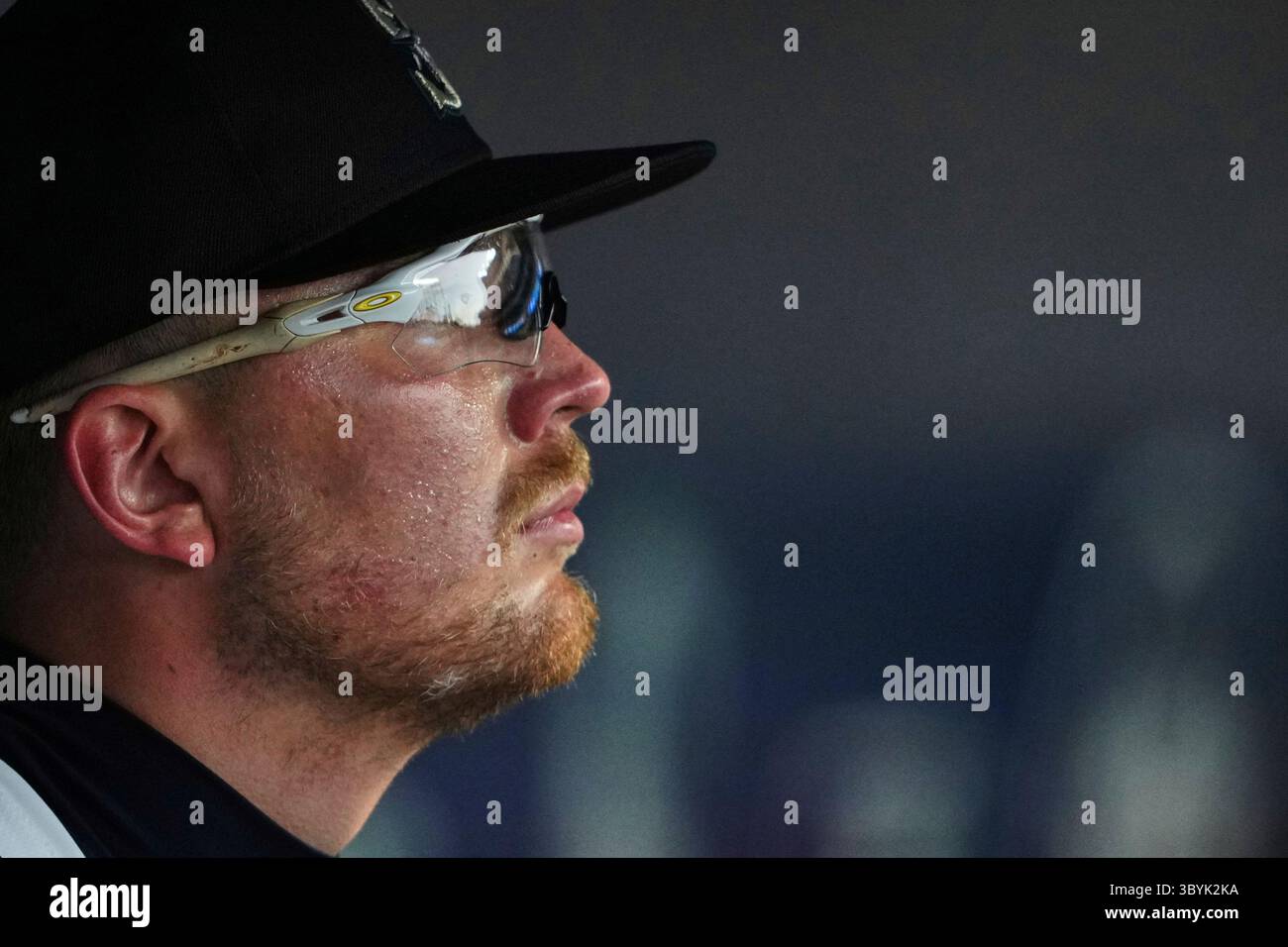 Seattle Mariners starting pitcher Logan Evans stands in the dugout ...
