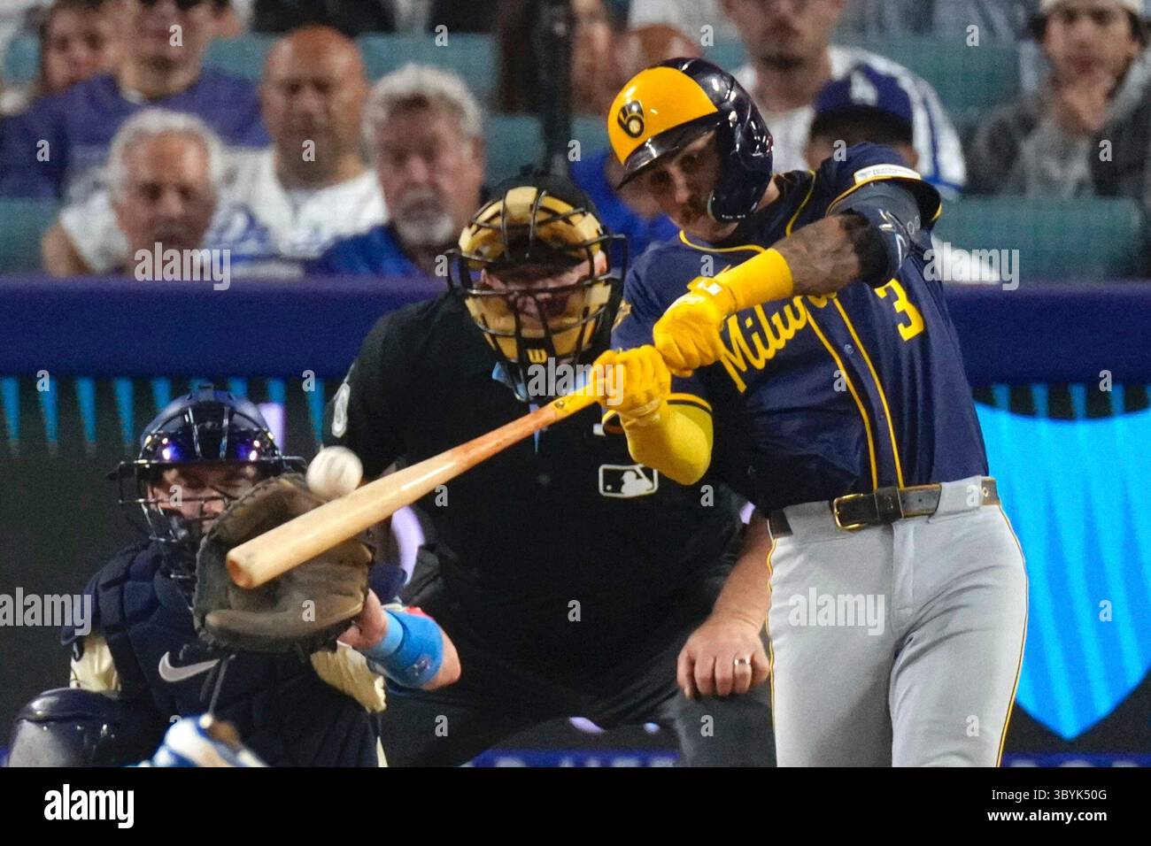 Milwaukee Brewers' Joey Ortiz, right, hits a solo home run as Los ...