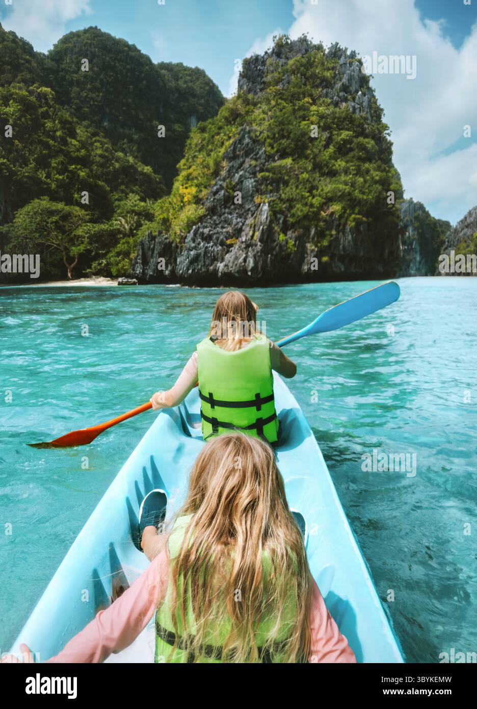 Family mother and daughter paddling a kayak in Philippines travel ...