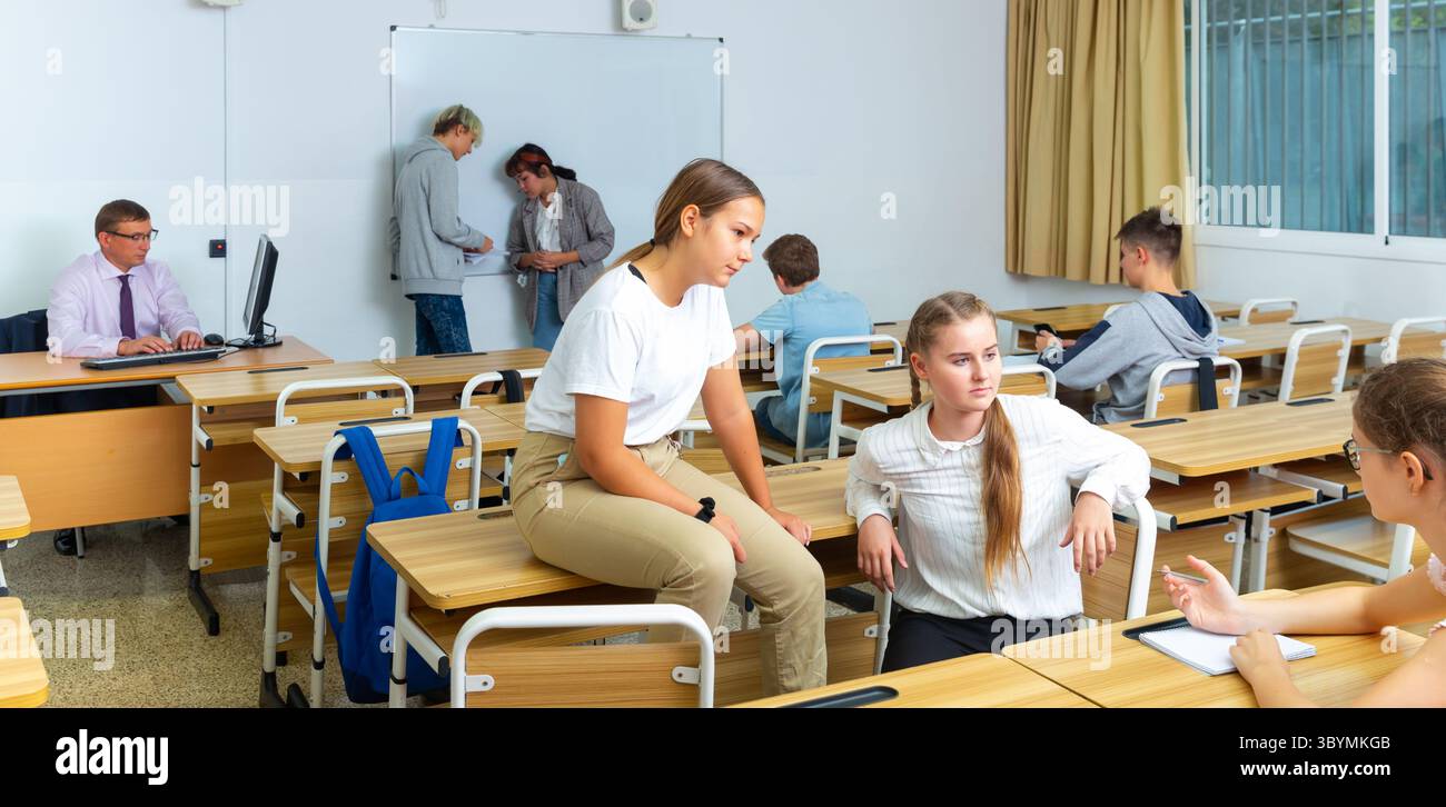 Teenage students talking during recess between lessons Stock Photo - Alamy
