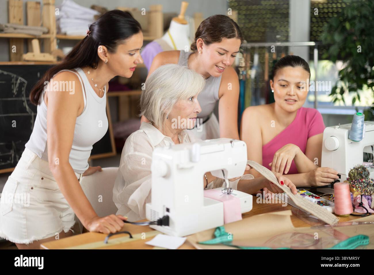 Mature woman showing how to sew Stock Photo - Alamy