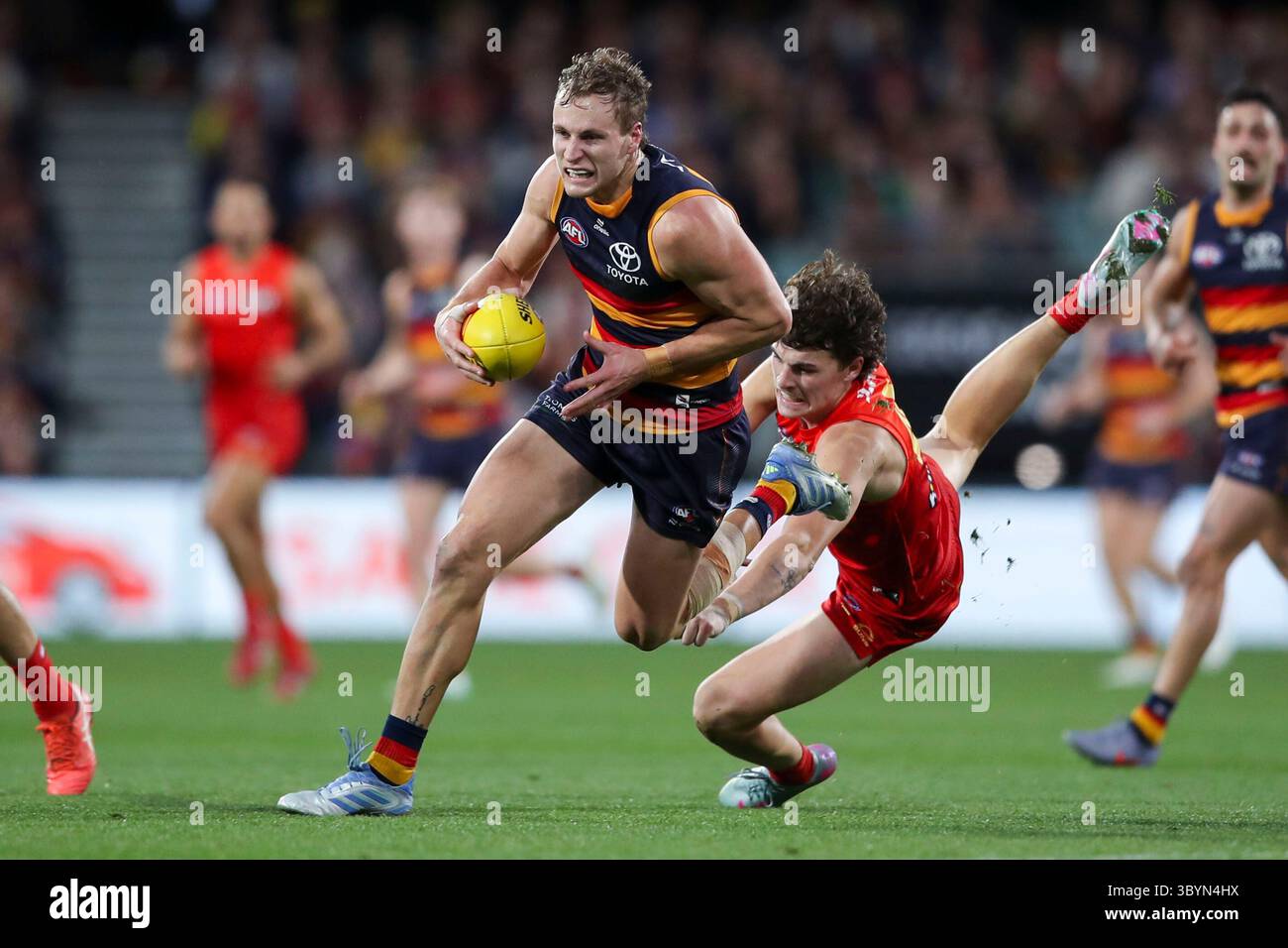 Jordan Dawson of the Crows evades Oscar Adams of the Suns during the ...