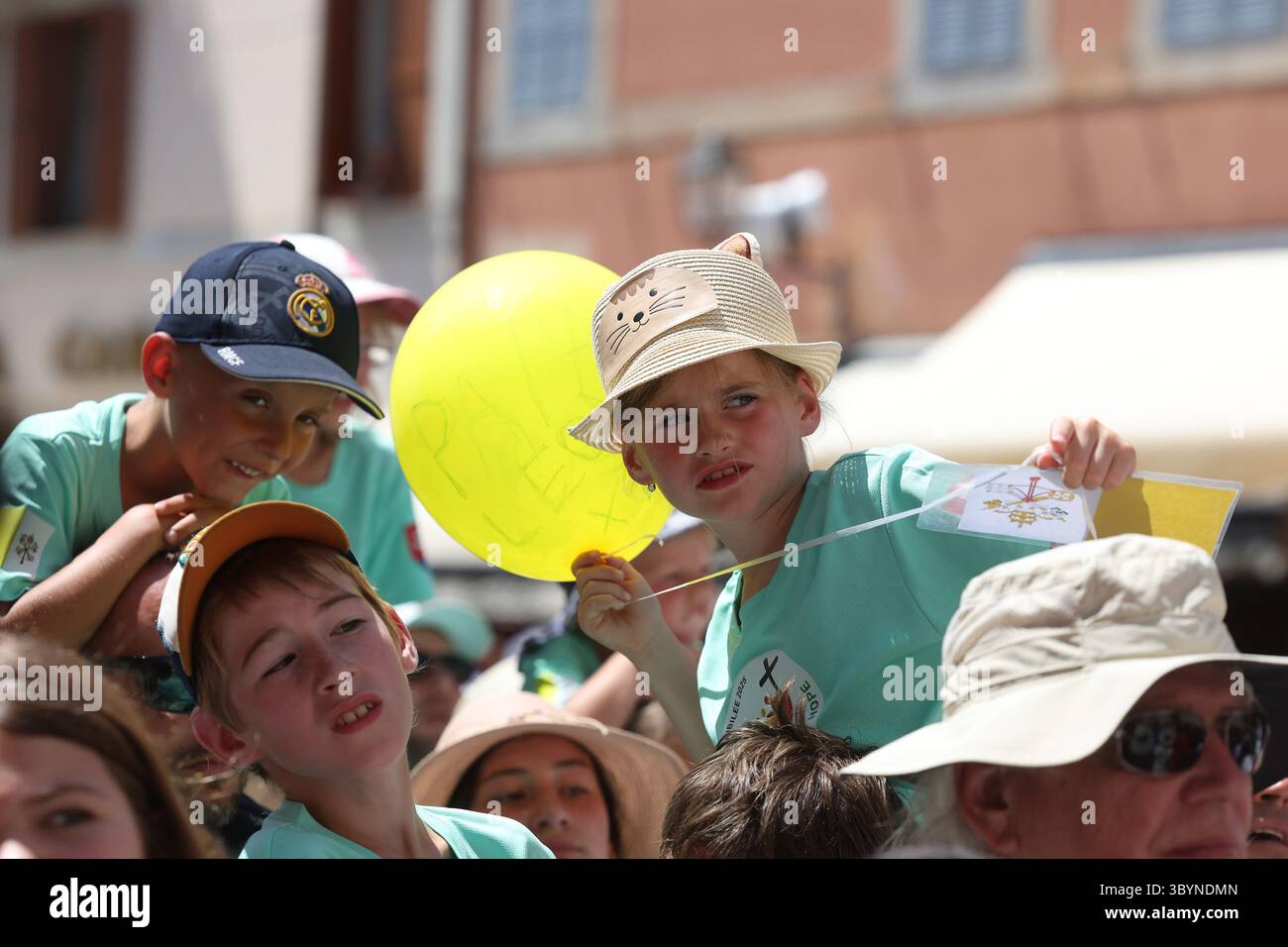 Castelgandolfo, Italy, July 20, 2025: Children wearing hats and yellow ...