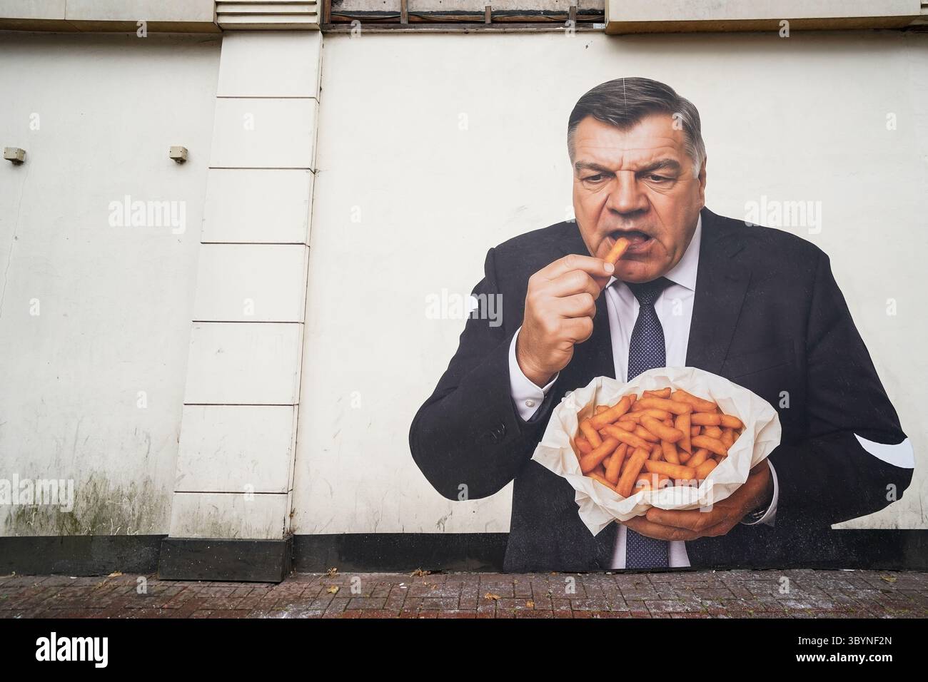A mural of former England football manager Sam Allardyce eating orange ...