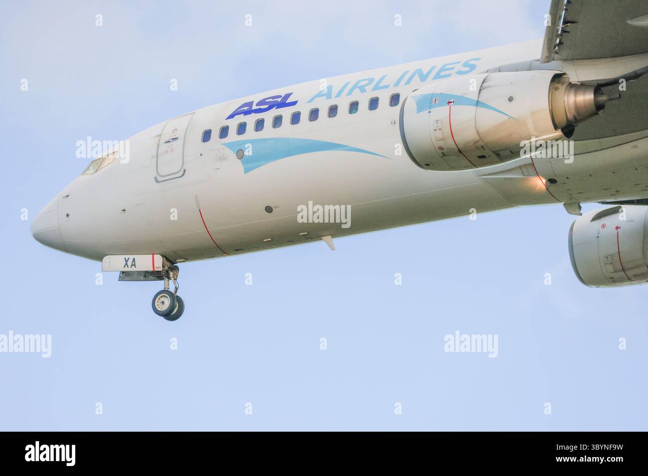 White boeing 737 airplane with blue stripes is landing at lisbon ...
