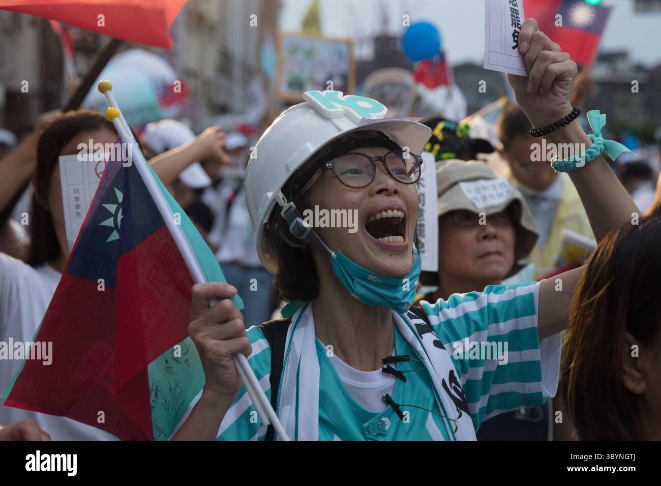 Supporters of the Taiwan People s Party hold placards and shout slogans ...