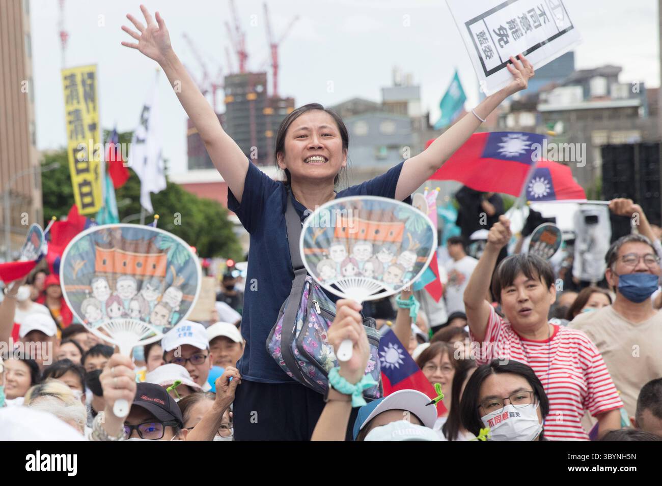 Supporters of the Taiwan People s Party hold placards and shout slogans ...