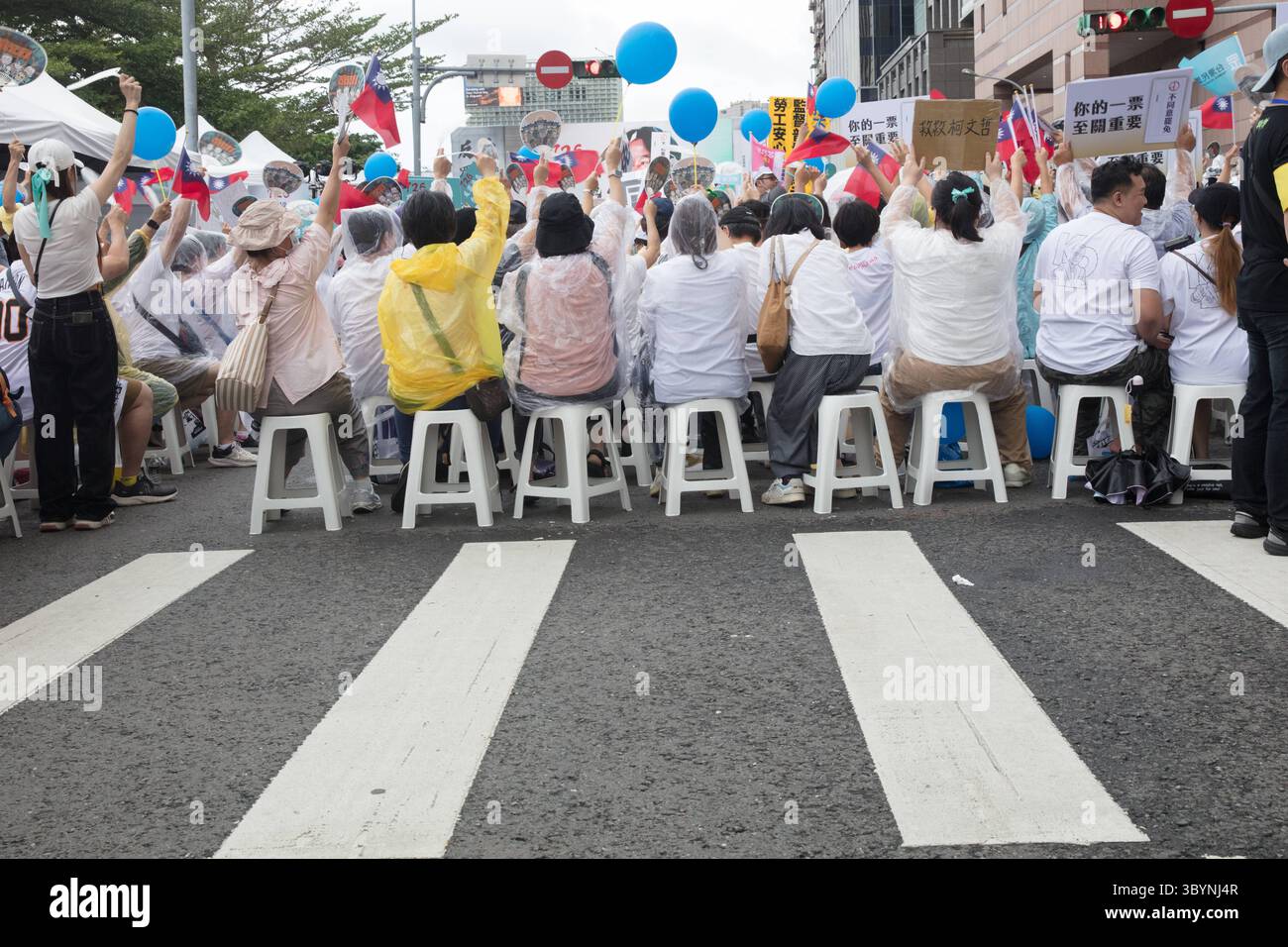 Supporters of the Taiwan People s Party hold placards and shout slogans ...