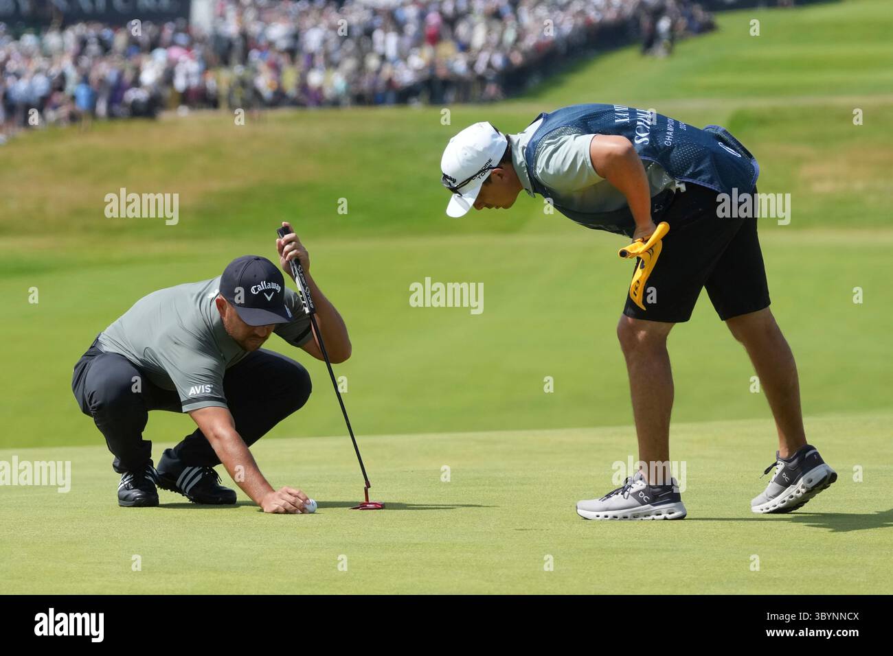 Xander Schauffele of the United States, left, and his caddie Austin ...