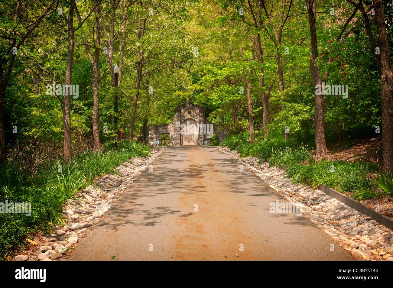 a driveway leading to a stone wall on the grey towers national historic ...