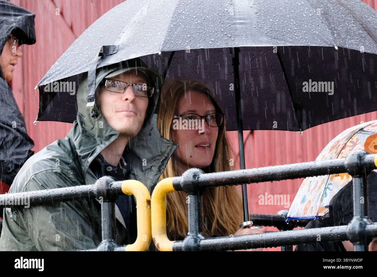 Bristol, UK. 20th July, 2025. Umbrellas on the train in the rain. Short ...