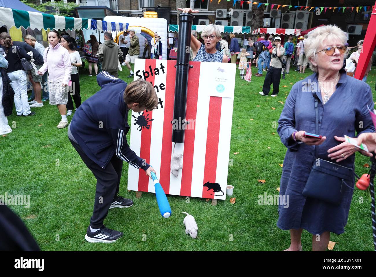 A person playing "splat the rat" at the 50th Soho Village Fete in ...