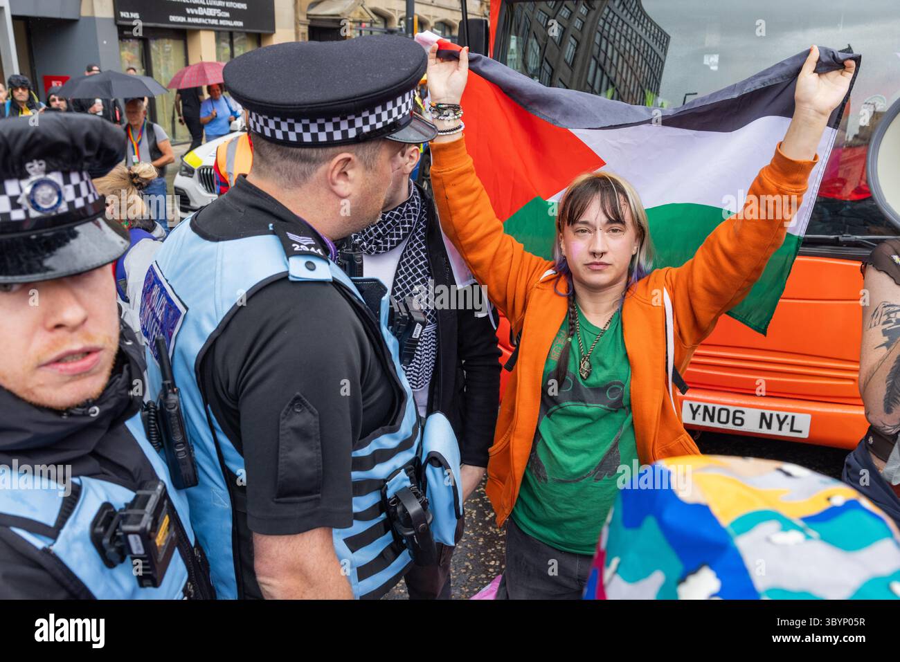 Leeds, UK. 20 JUL, 2025. Person holds flag as a collective of queer ...
