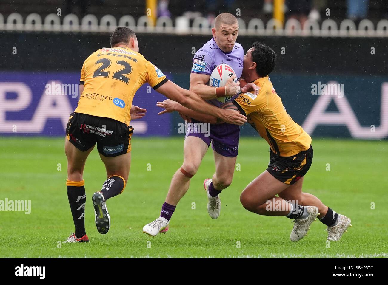 Warrington Wolves' Matthew Dufty (centre) is tackled by Castleford ...