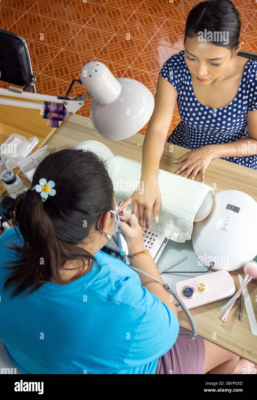 Professional providing nail care client hi-res stock photography and ...
