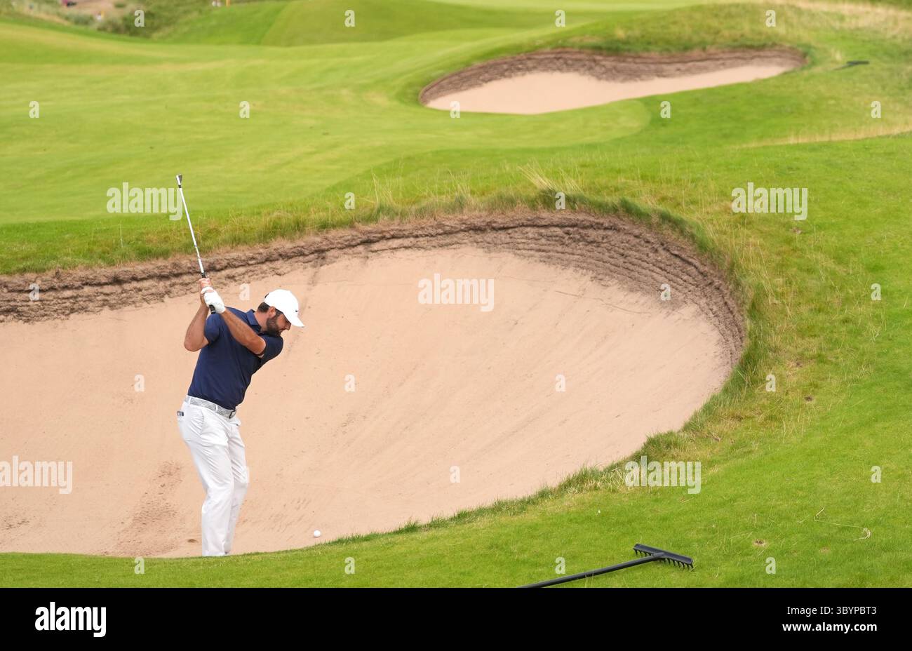 USA's Scottie Scheffler chips out of a bunker on the 8th during day ...