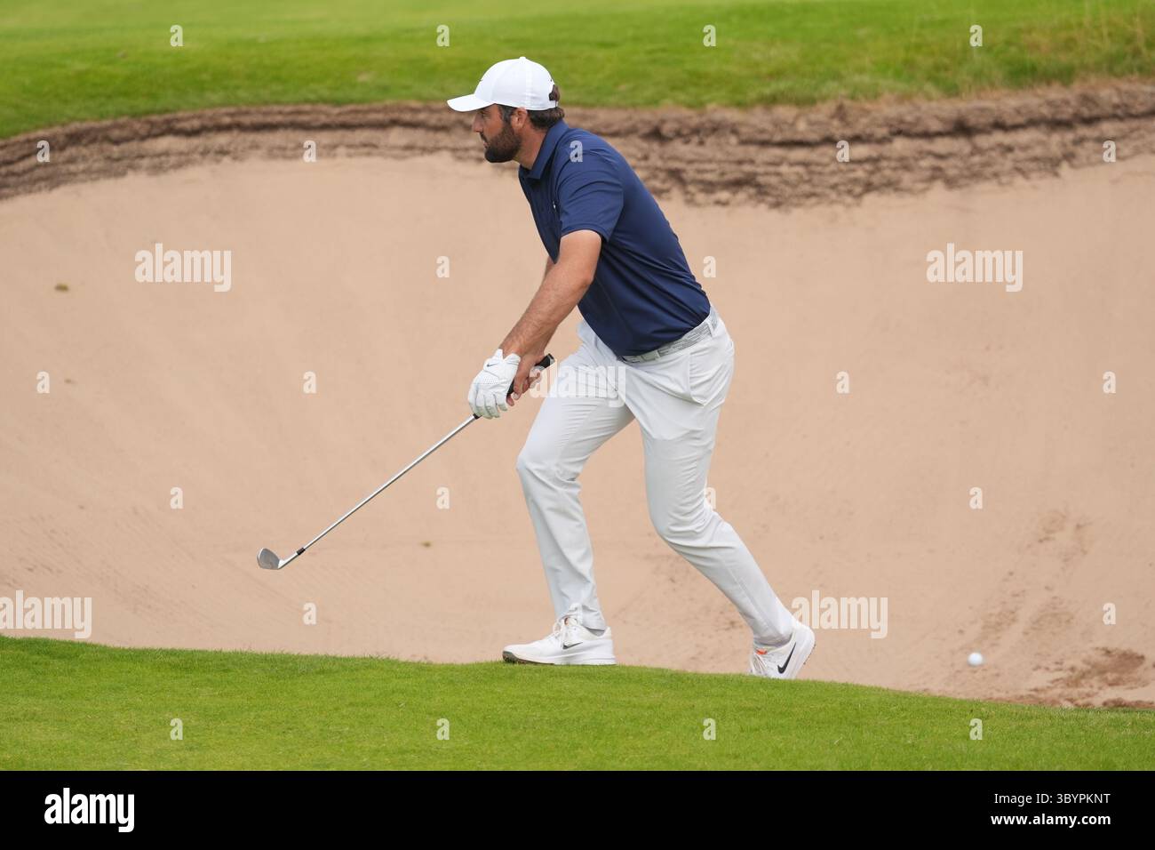 USA's Scottie Scheffler chips out of a bunker on the 8th during day ...