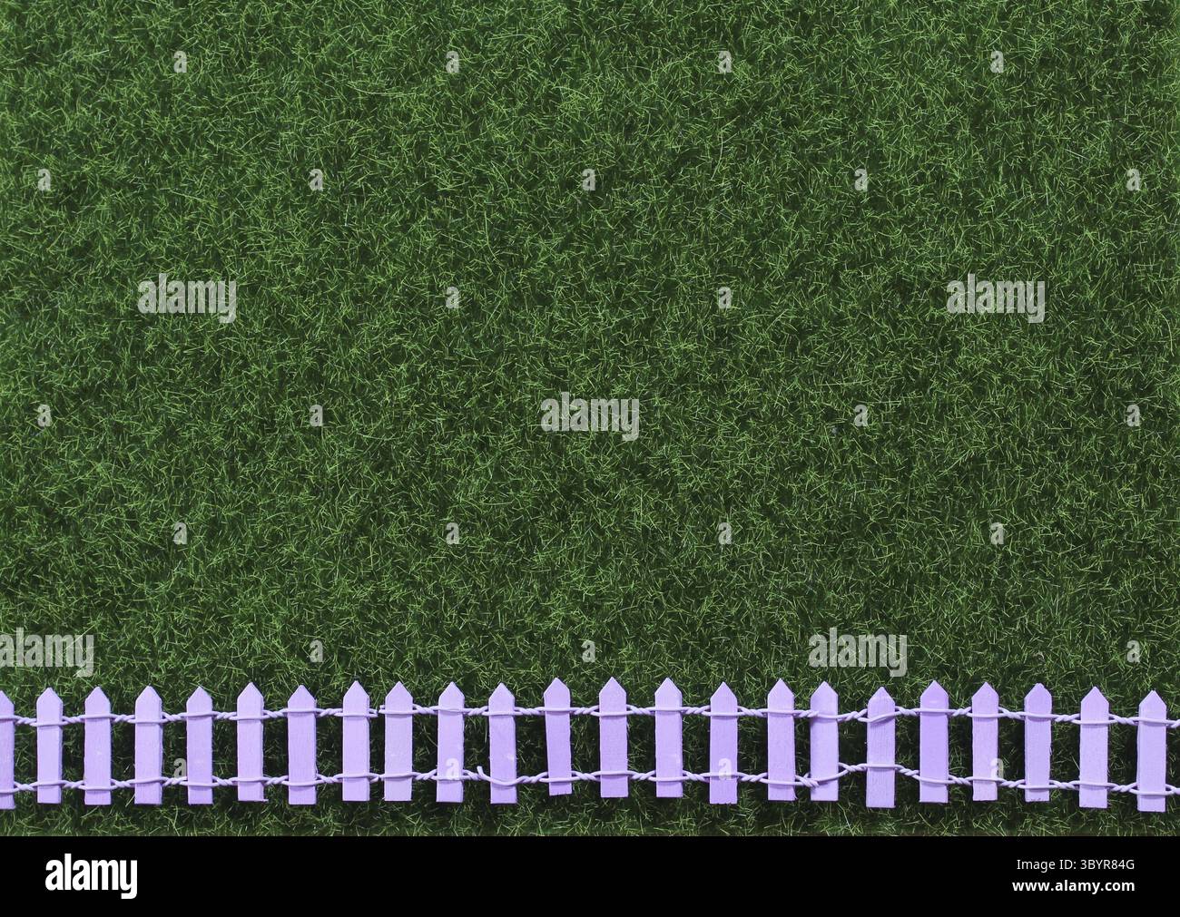 Picket Fence on Artificial Grass Background Stock Photo - Alamy