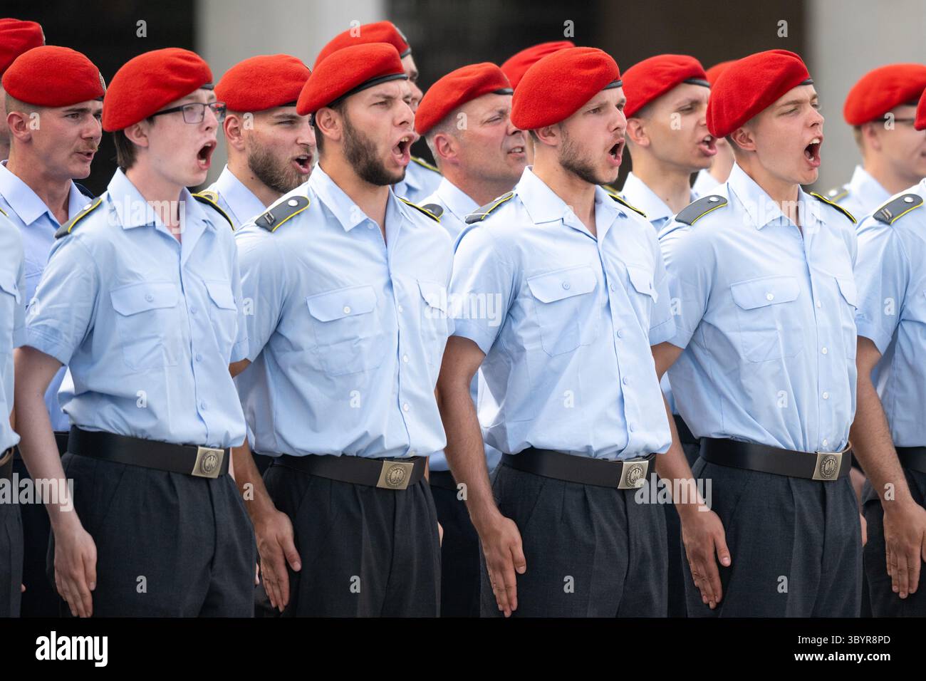 20 July 2025, Berlin: Recruits shout their battle cry at the end of the ...