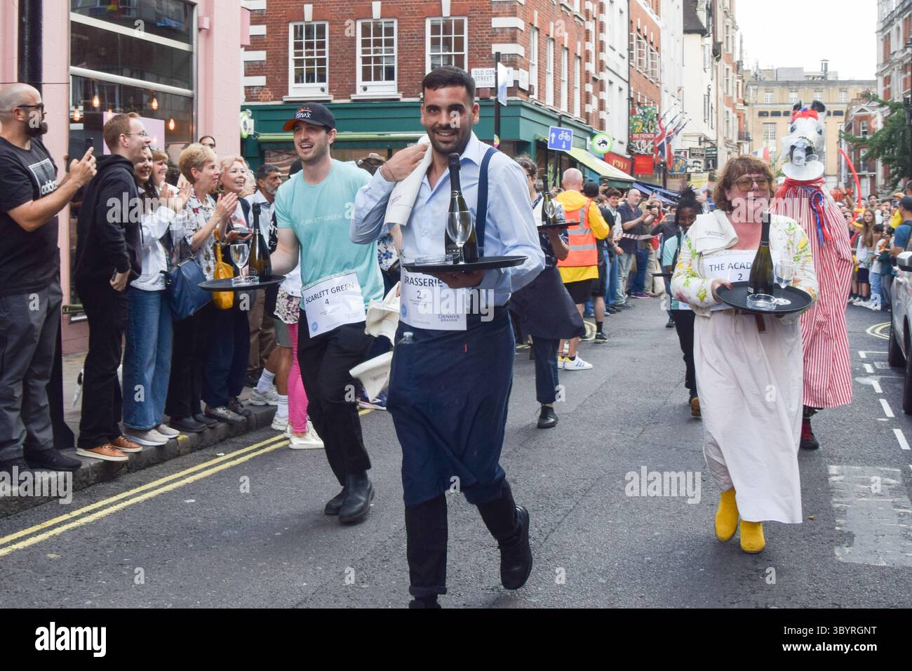 London, UK. 20th July 2025. Waiters take part in the Soho Waiters' Race ...