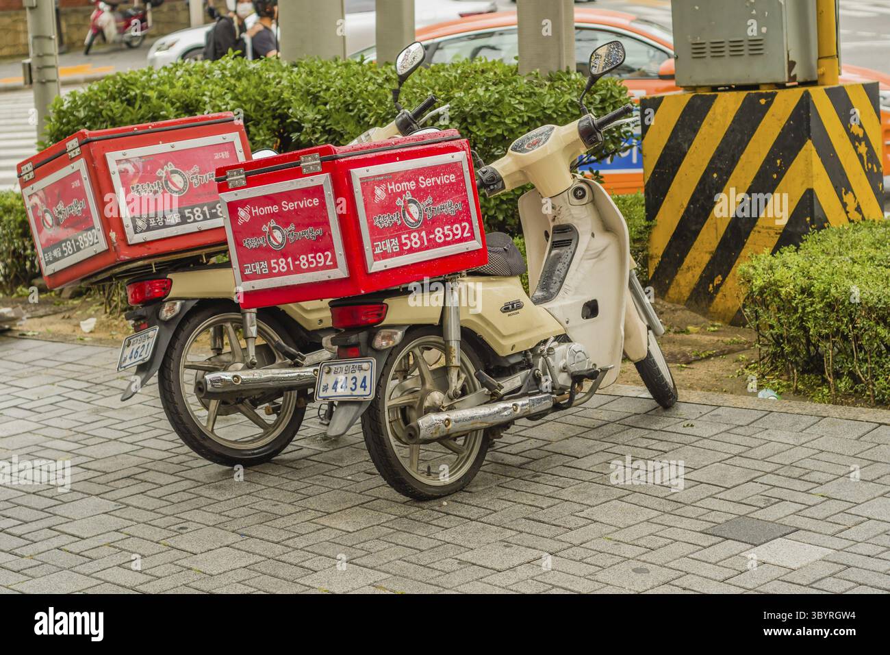 Seoul, South Korea. July 2, 2018: Two delivery motor scooters with red ...