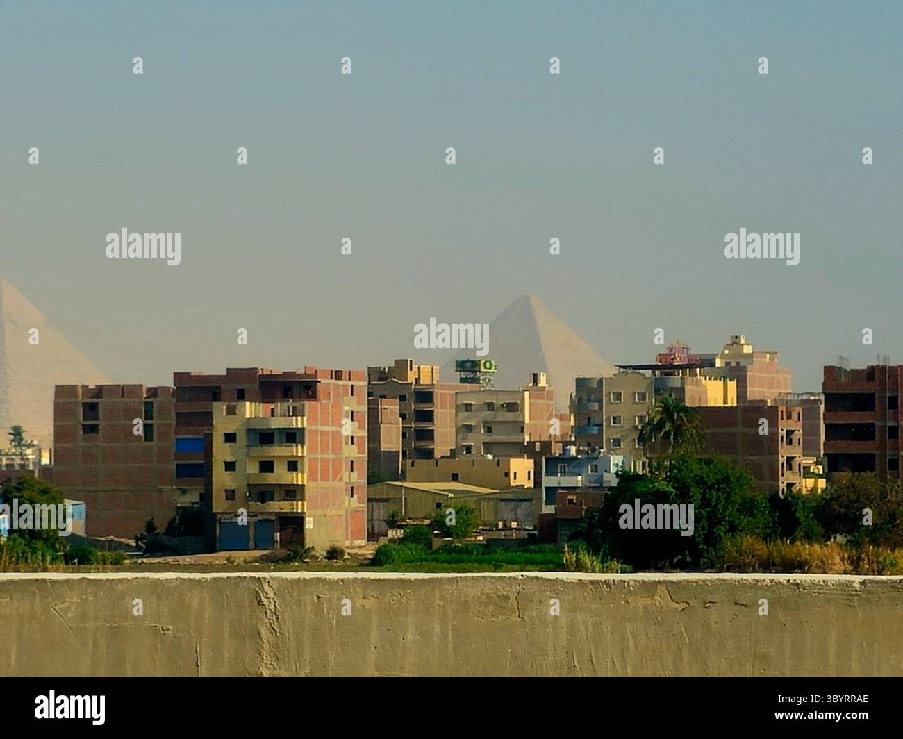 Giza, Egypt, July 6 2025: the buildings and the pyramids of Giza from ...