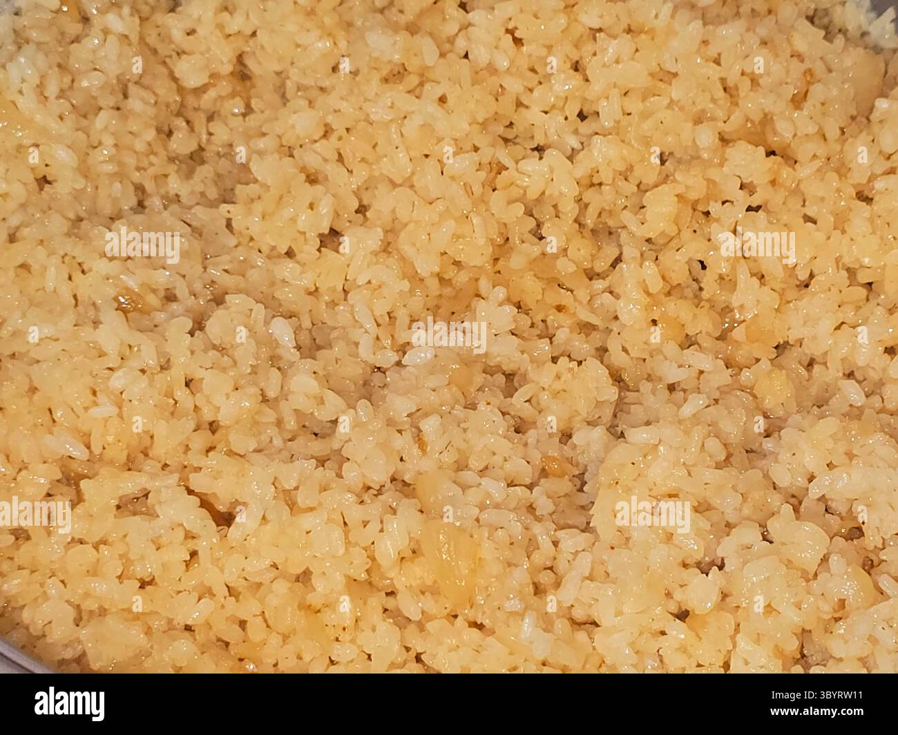 Cooked white Egyptian rice by hot steam and gained the brown color from ...