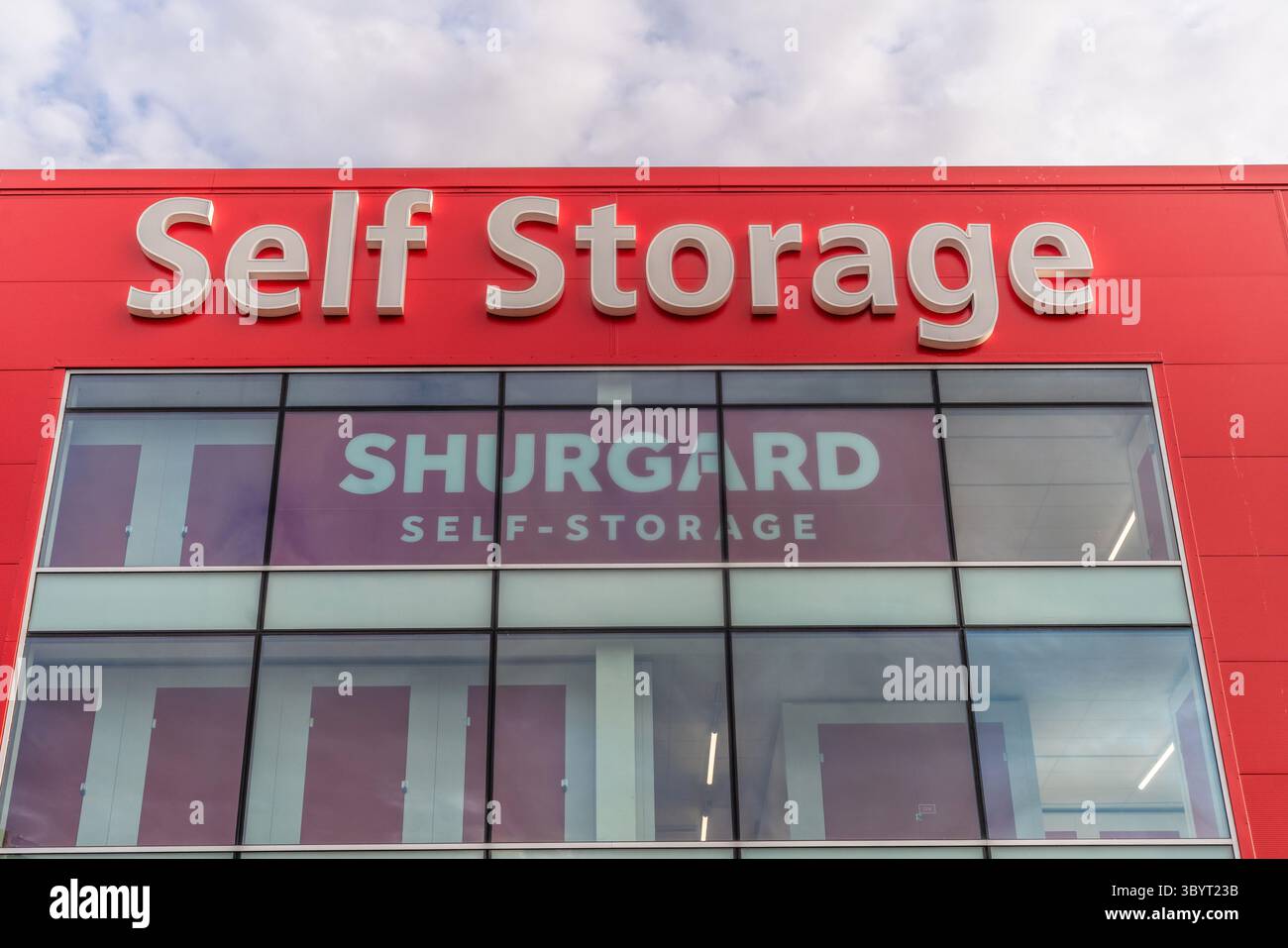 Red themed glass building facade of a Shurgard self storage facility ...