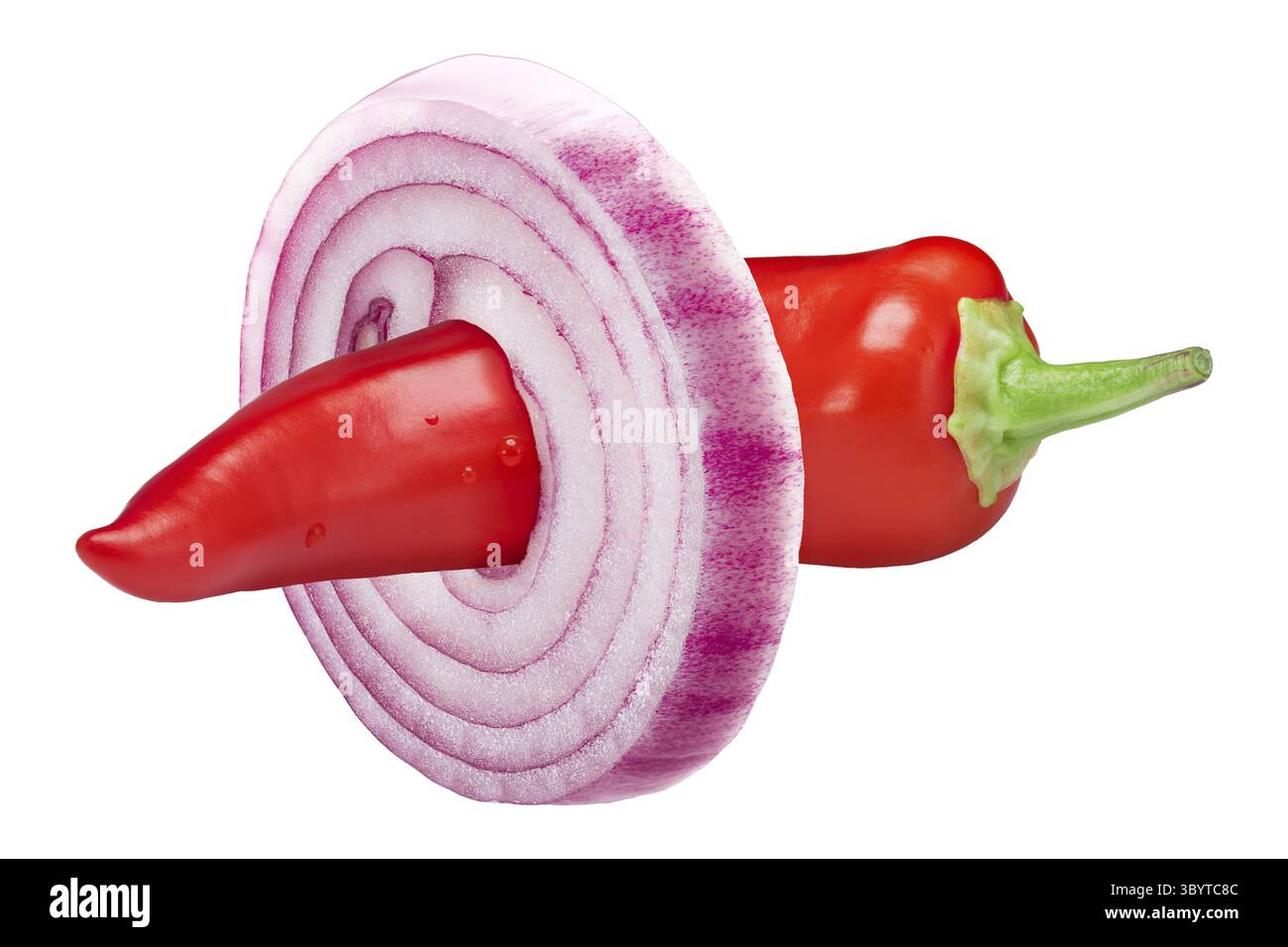 Red chile pepper (paprika pod) stuck into purple onion slice. Clipping ...