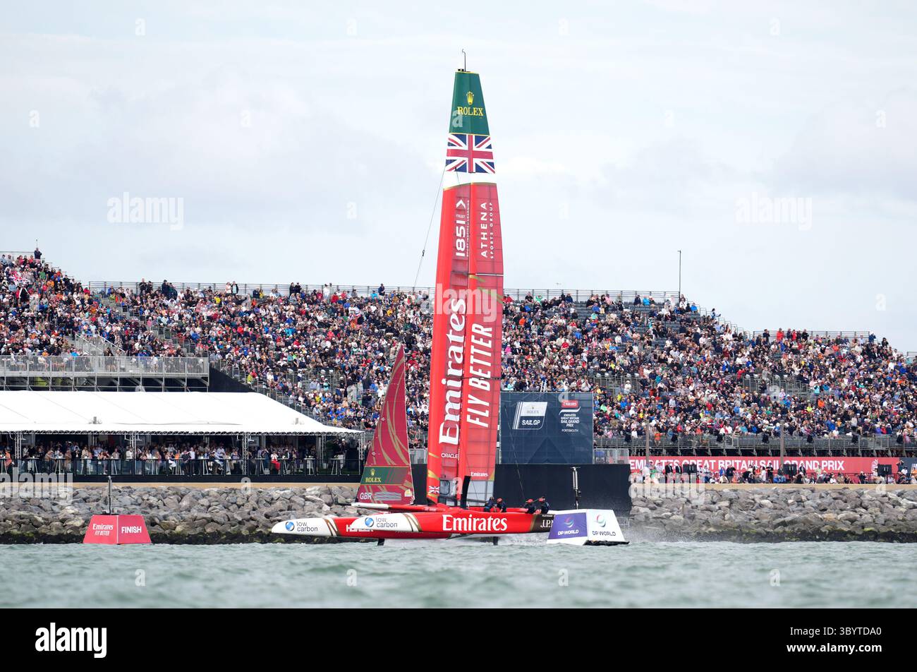 The Emirates Great Britain SailGP team boat crosses the finish line ...