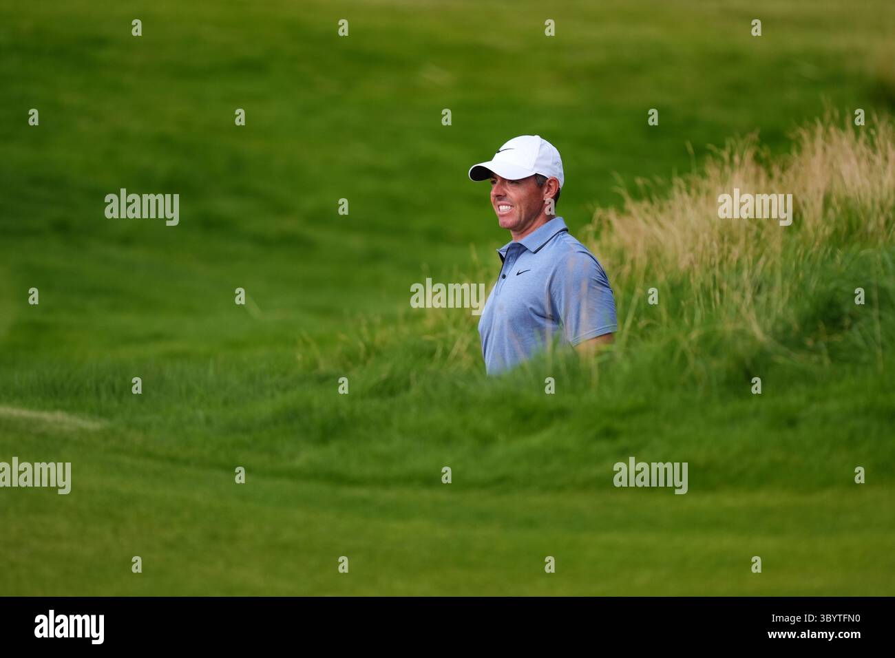 Northern Ireland's Rory McIlroy chips out of a bunker on the 17th ...