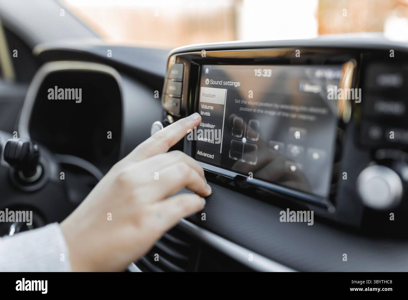 Adjusting Language with touchscreen of a modern car. Driving at a sunny ...