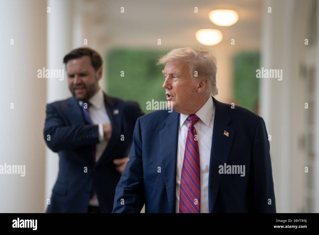 President Donald Trump and Vice President JD Vance walk along the West Colonnade, Friday, July ...