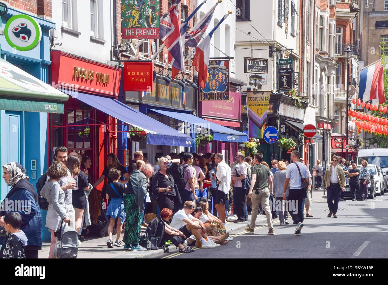 London, UK. 20th July 2025. People outside pubs and bars in Dean Street ...