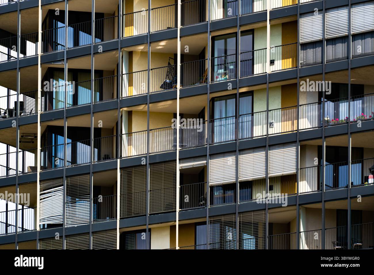 Residential tower with deep balconies and a grid of glass and concrete ...
