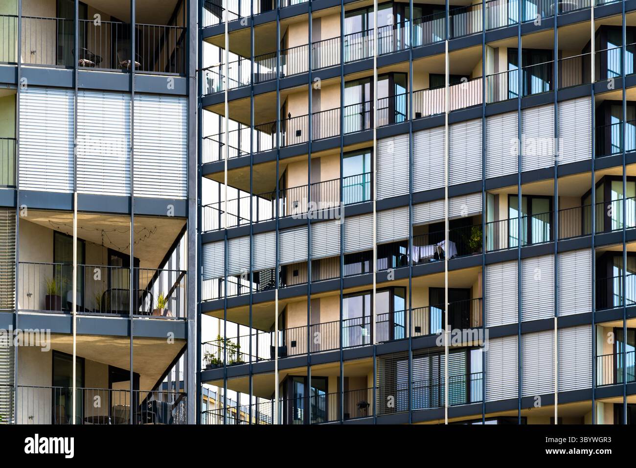 Residential tower with deep balconies and a grid of glass and concrete ...