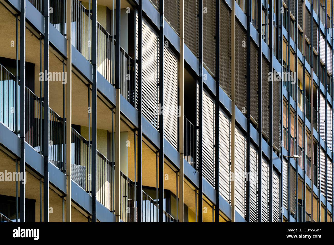Residential tower with deep balconies and a grid of glass and concrete ...