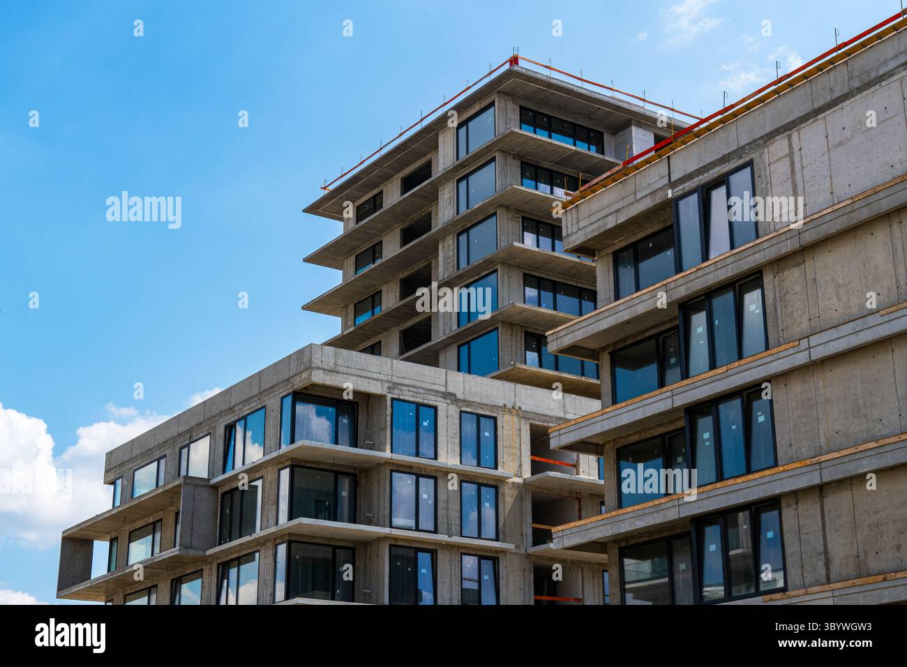Residential building under construction with exposed concrete and glass ...