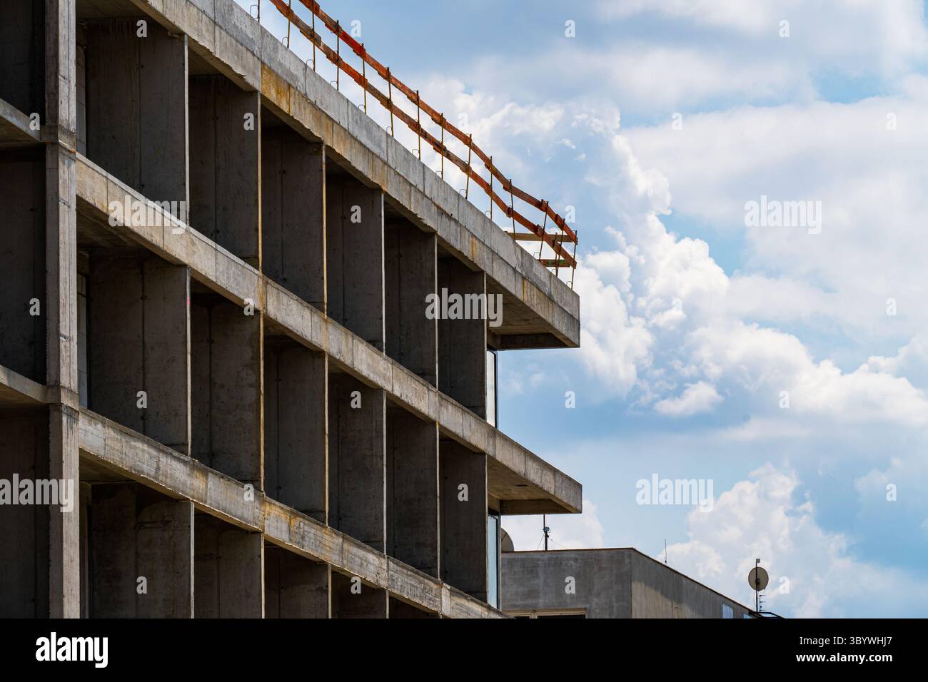 Residential building under construction with exposed concrete and glass ...
