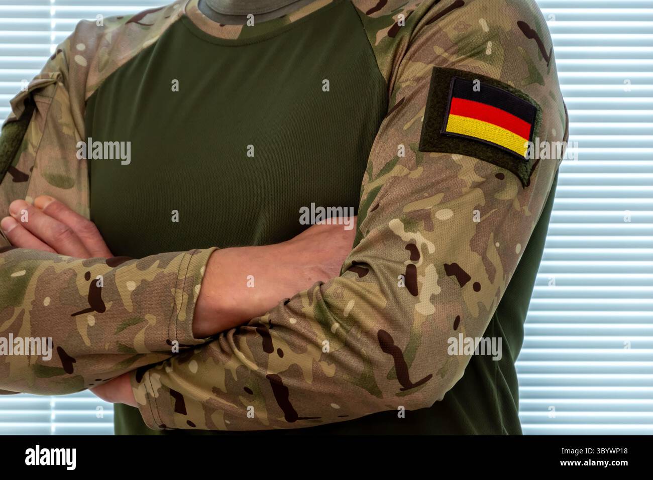 German flag on the sleeve of camouflage uniforms. A symbol of military ...