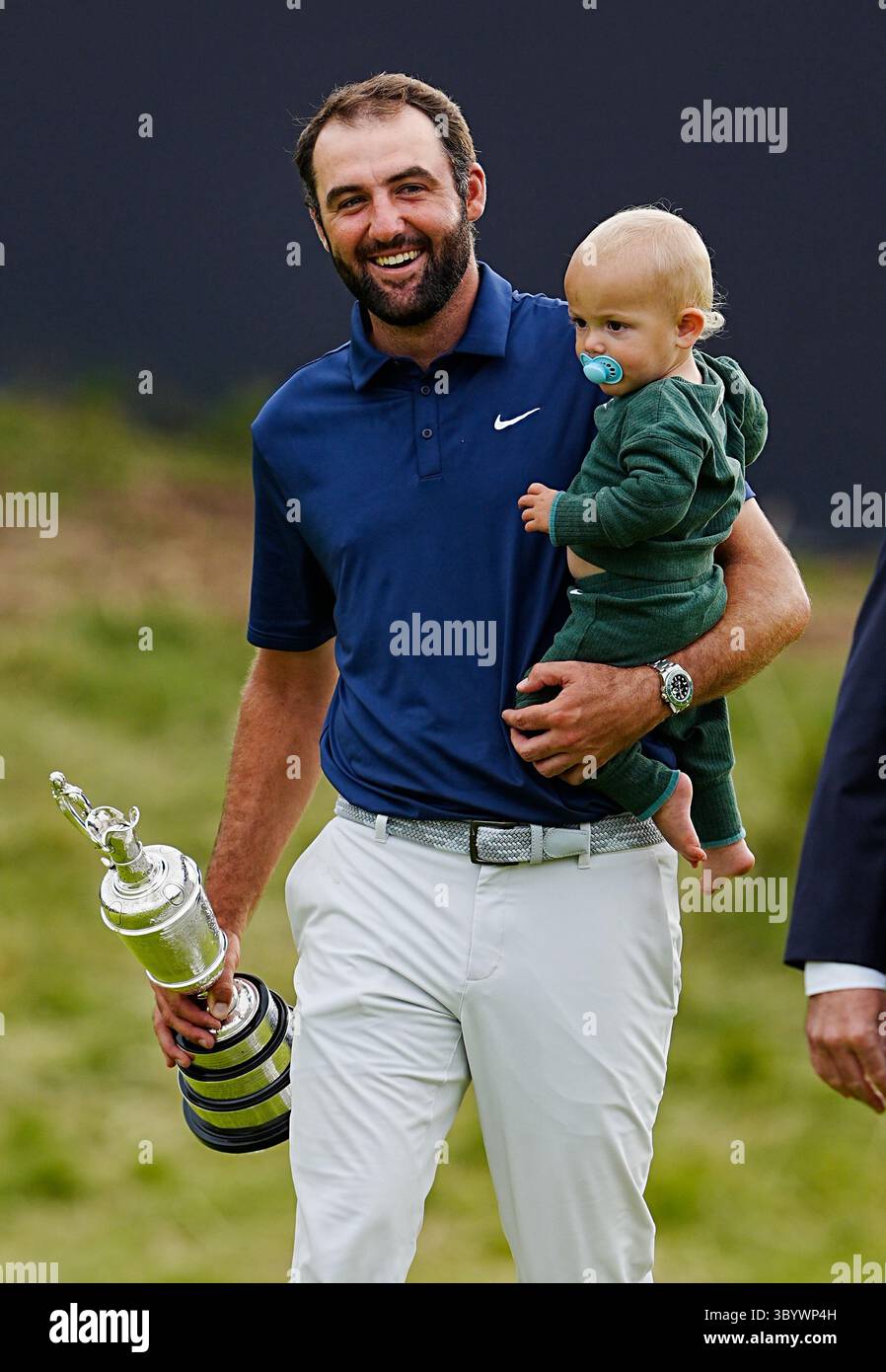 USA's Scottie Scheffler with son Bennett and the Claret Jug after ...