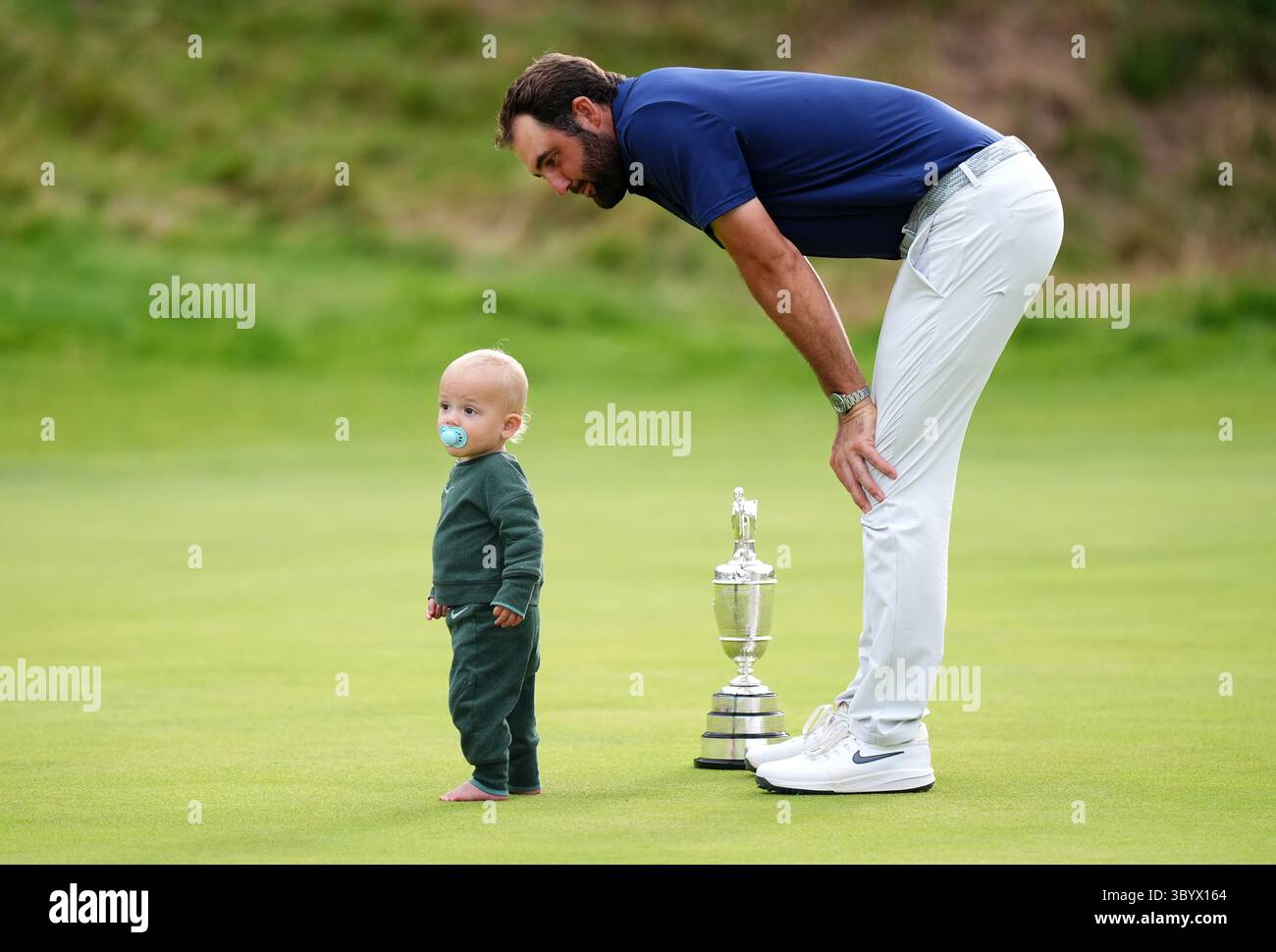 USA's Scottie Scheffler with son Bennett and the Claret Jug after ...
