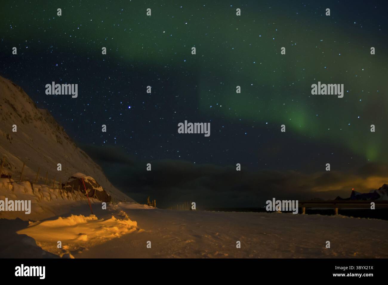 Norwegian Lofoten. Winter night. Many stars in the sky. Thick clouds on ...