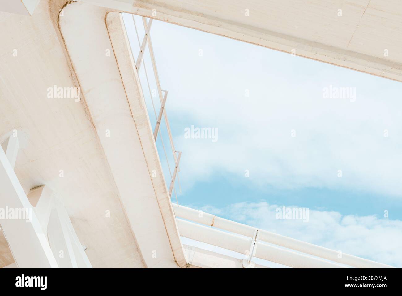 Minimalist upward view of layered white bridges and rails against blue ...
