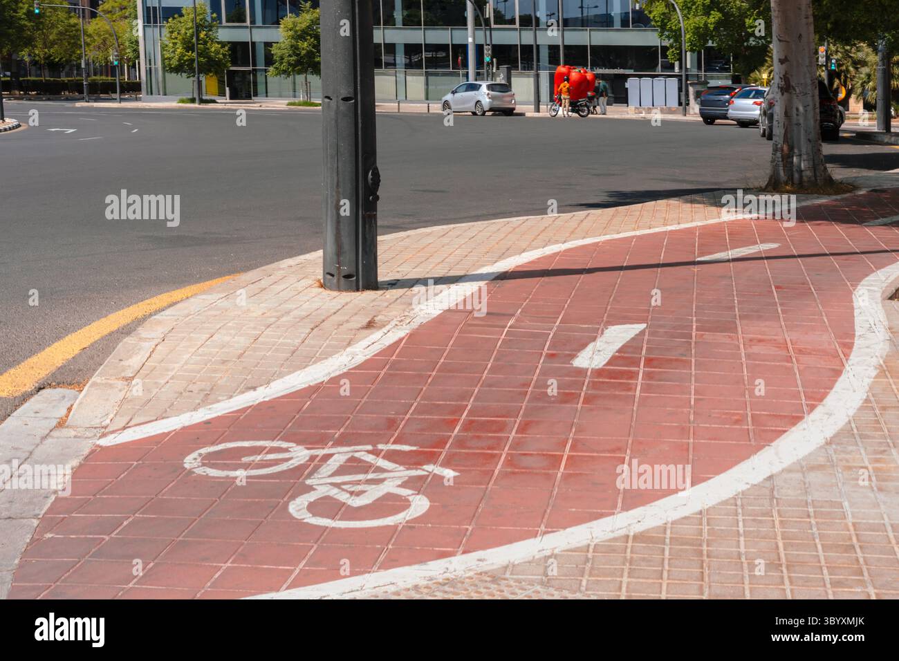 Curved red bike lane with clear white markings as part of city ...