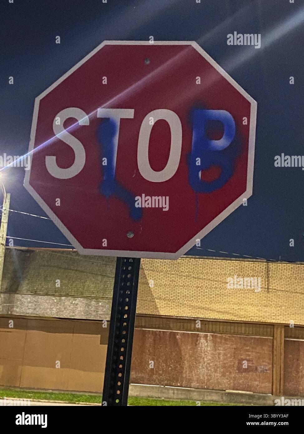 ScoreGang, "SLOB" tag in blue paint written over stop sign, on the ...