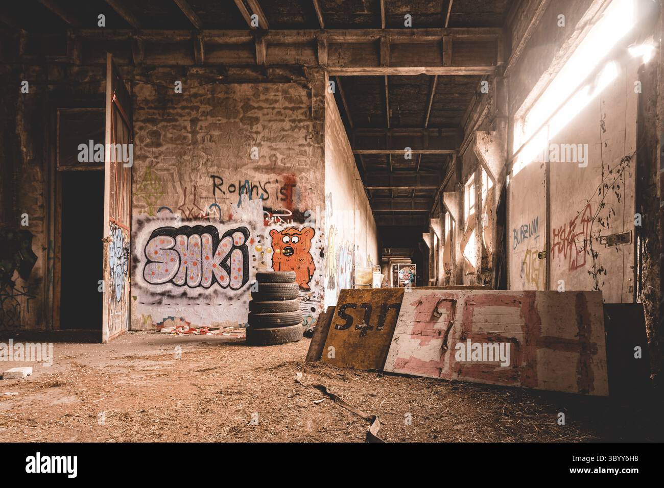 An old abandoned industrial area, with lots of graffiti that is slowly ...