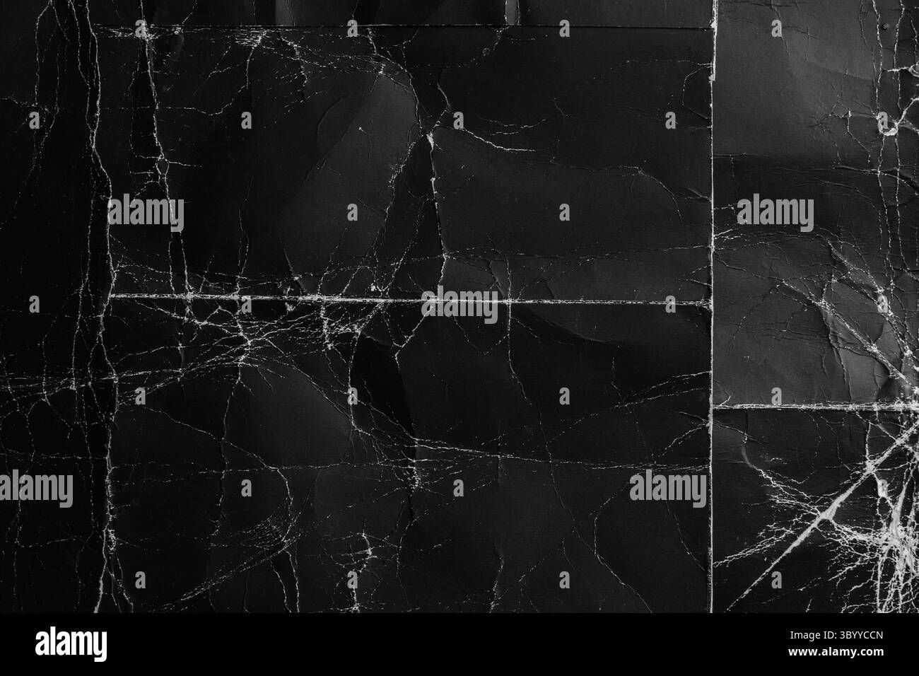 Geometric lines of aged folds and worn wrinkles on a black distressed ...